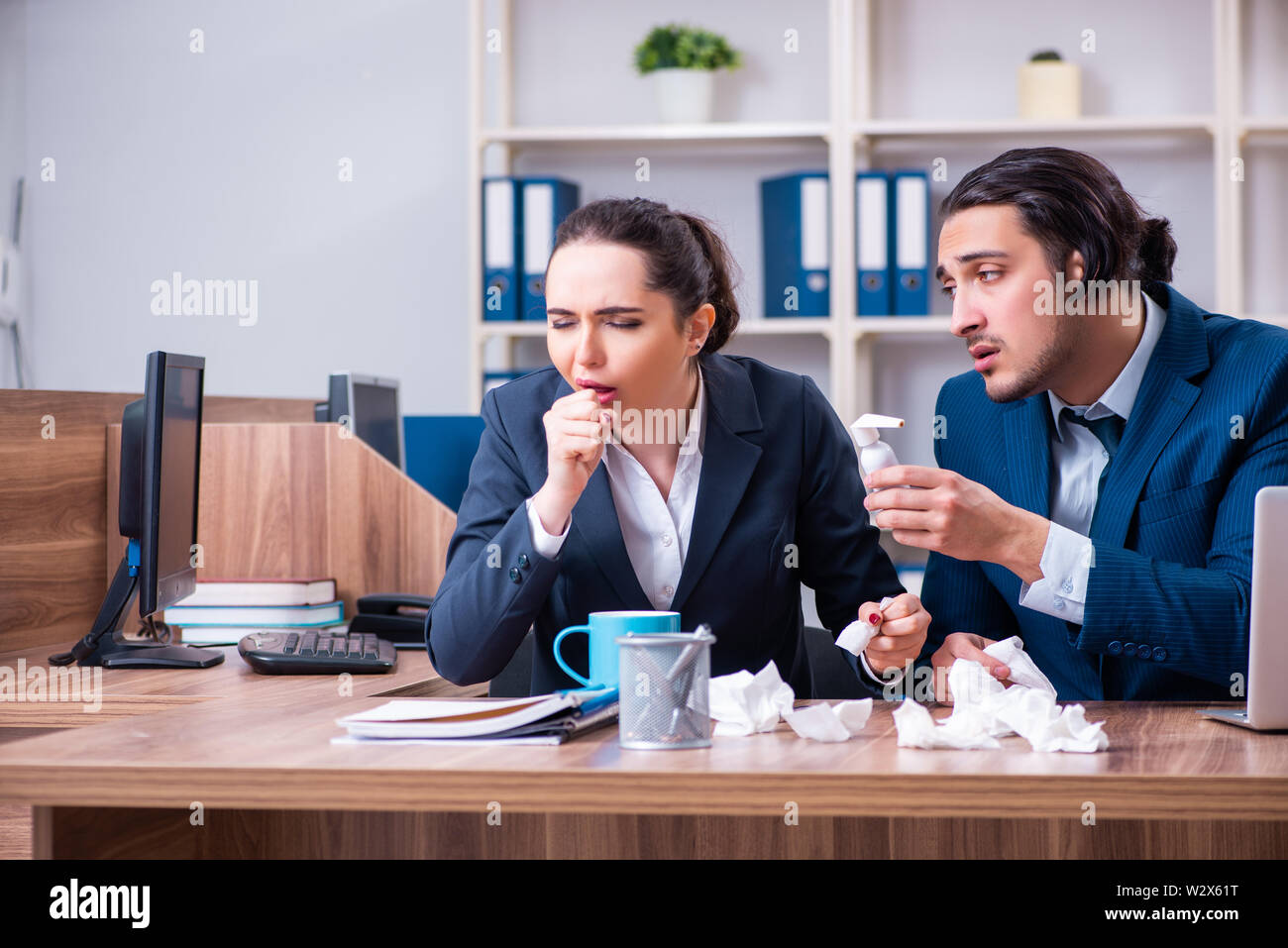 The two employees suffering at workplace Stock Photo - Alamy