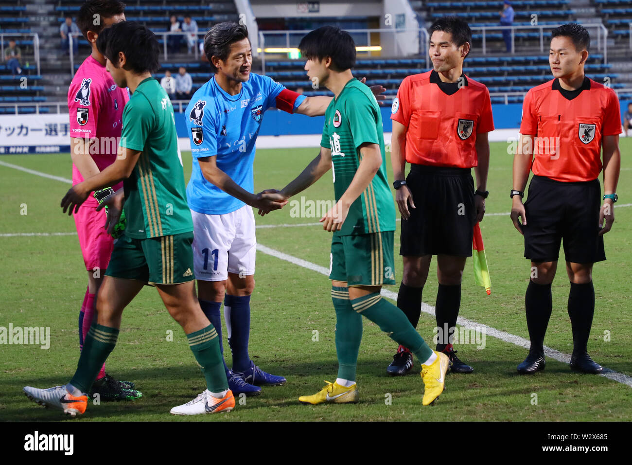 Yokohama FC's Kazuyoshi Miura shakes hands with Sendai University's ...