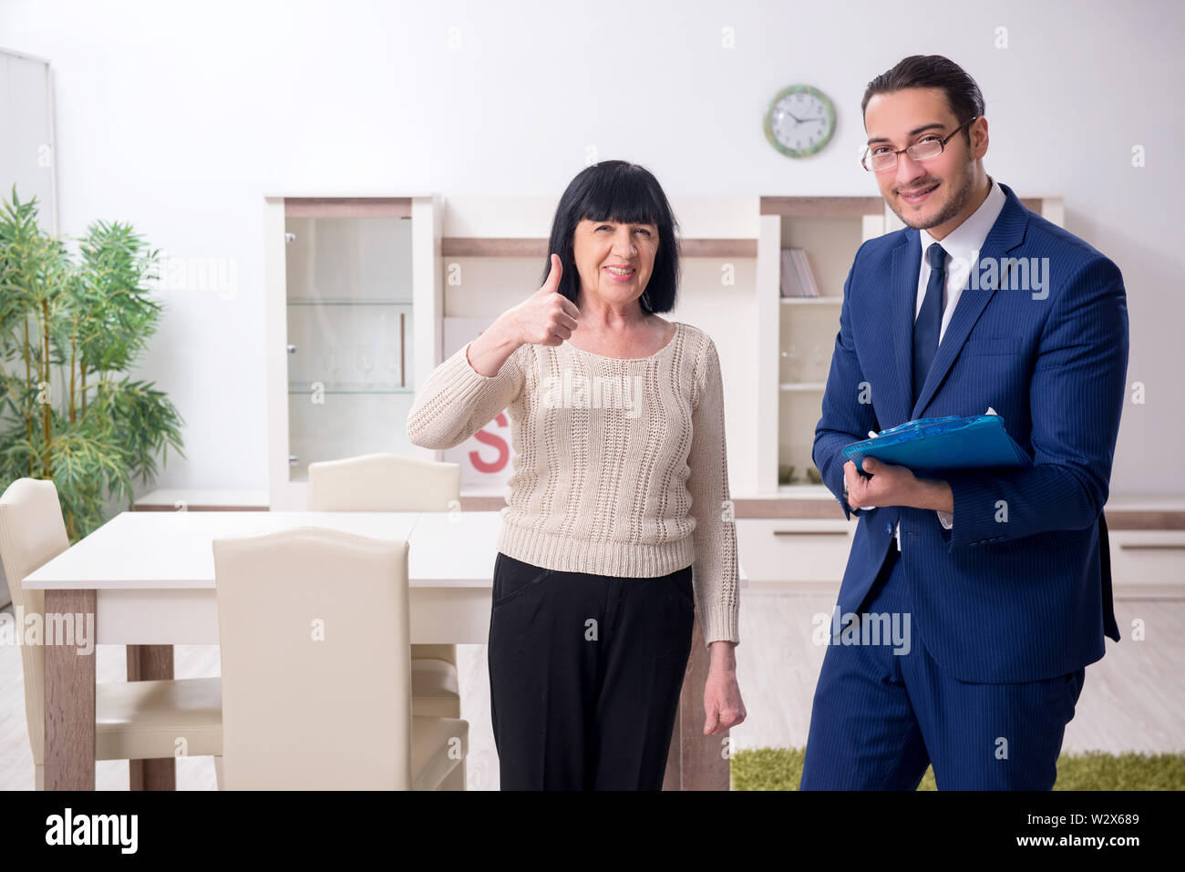 The male real estate agent and female client in the apartment Stock ...