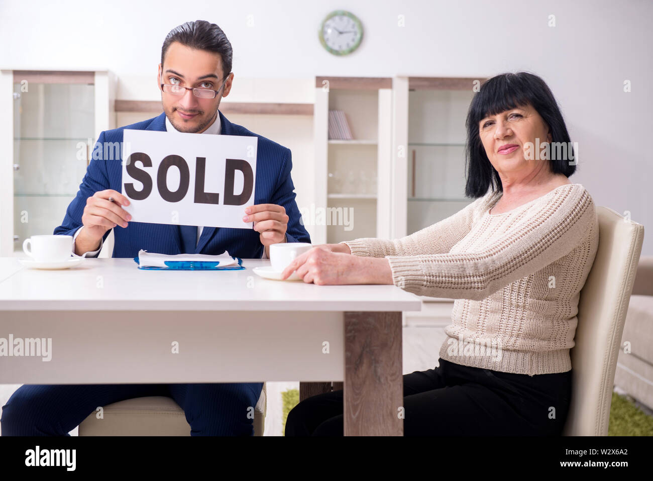 The male real estate agent and female client in the apartment Stock ...
