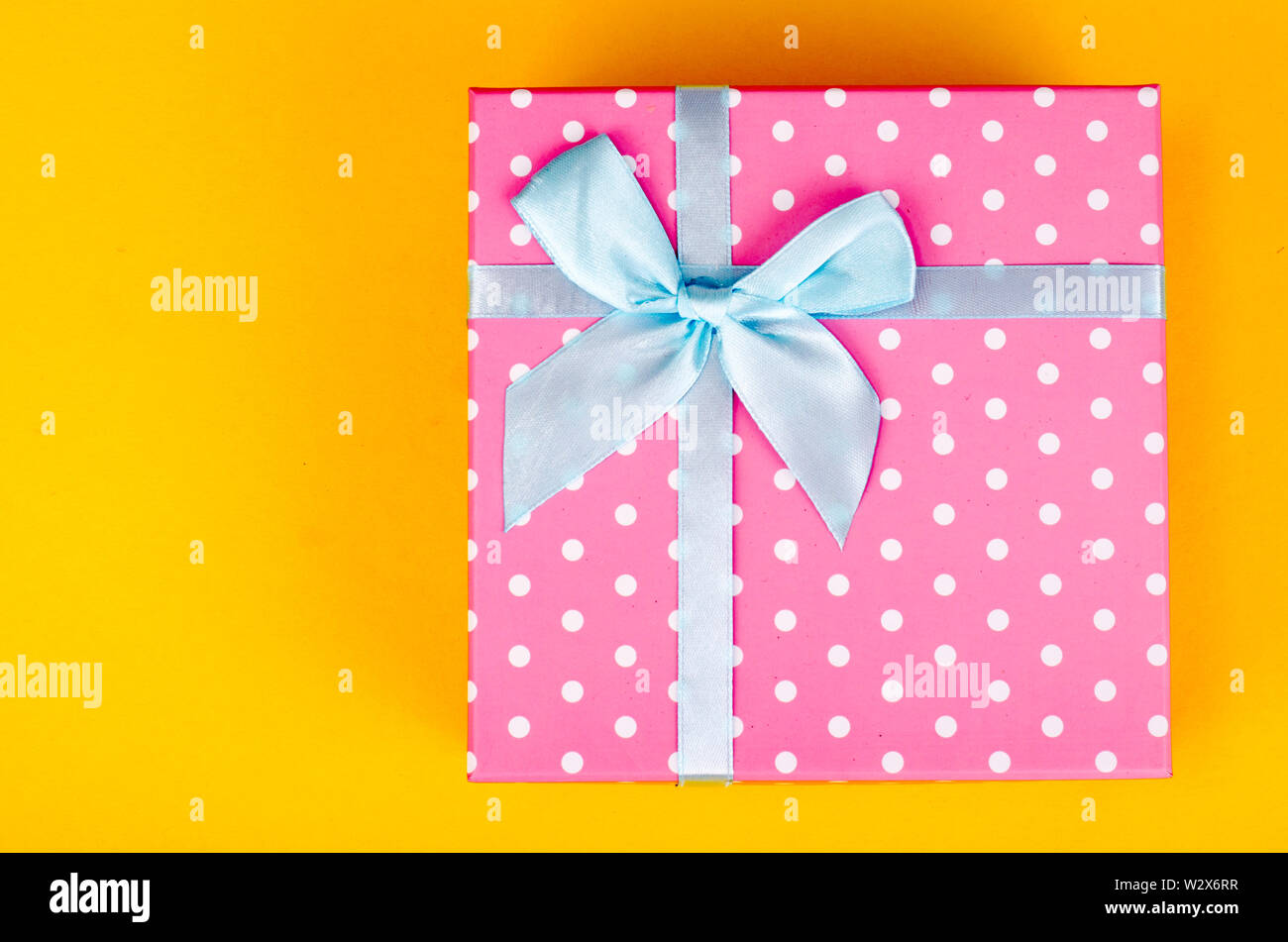 Square box of pink polka dots on bright background Stock Photo - Alamy