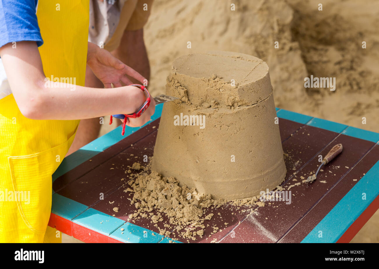 Child making a sand castle hi-res stock photography and images - Alamy