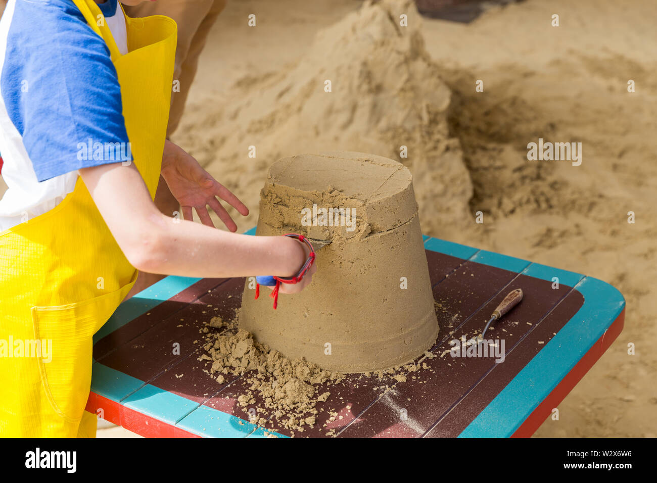 Kids on a craft lesson making sand castle on a beach Stock Photo - Alamy