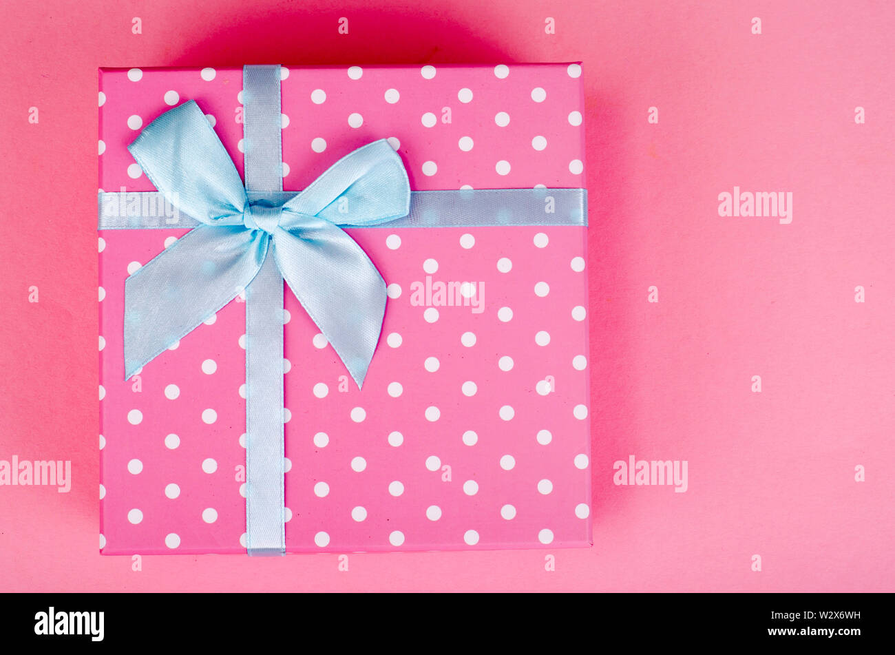 Square box of pink polka dots on bright background Stock Photo - Alamy