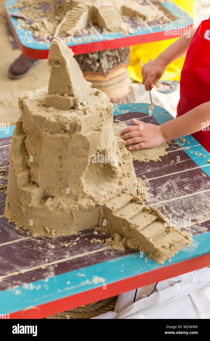 Sand castle made by kids on a craft lesson on summer beach Stock Photo ...