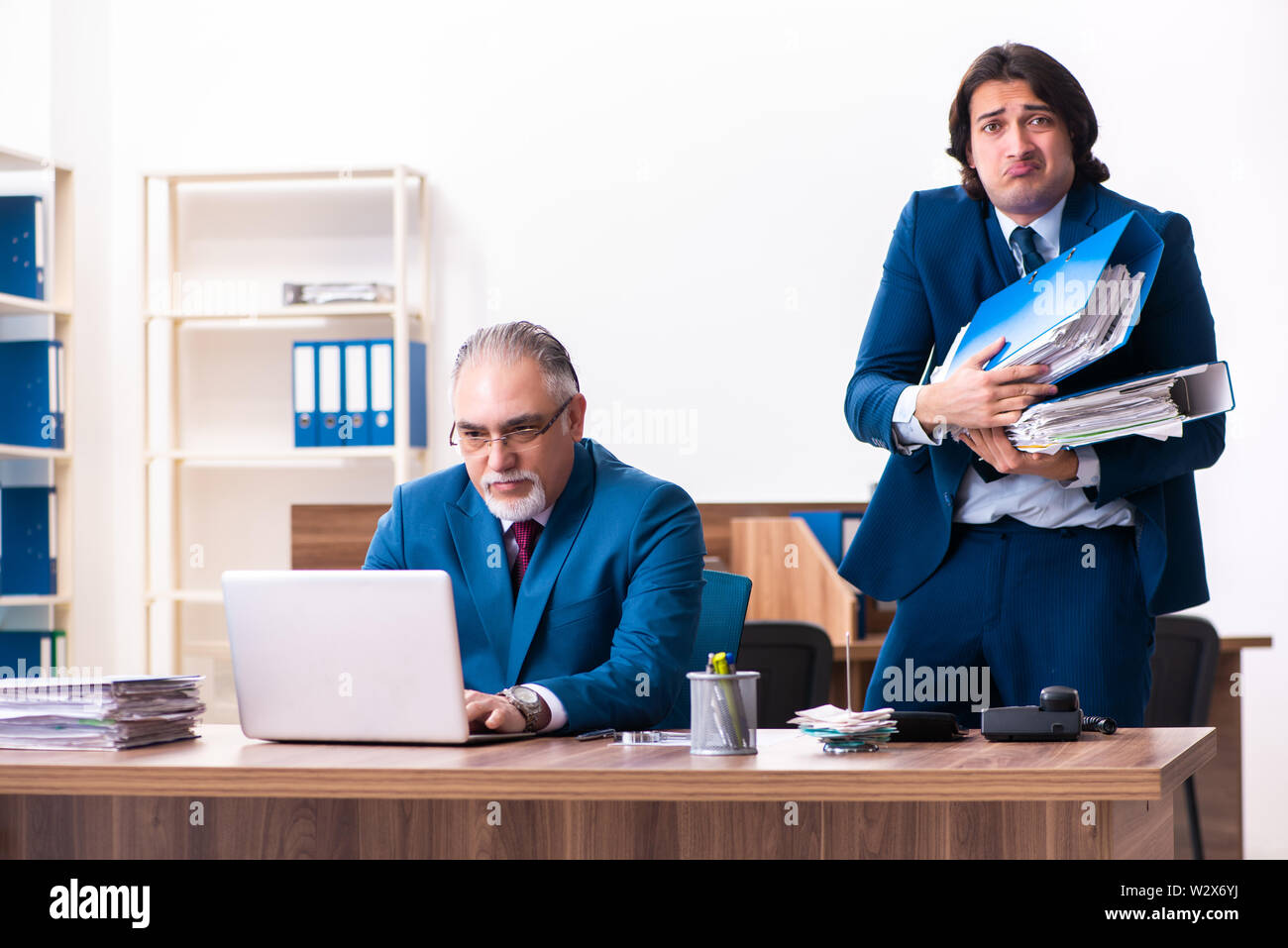 The young and old employees working together in the office Stock Photo ...