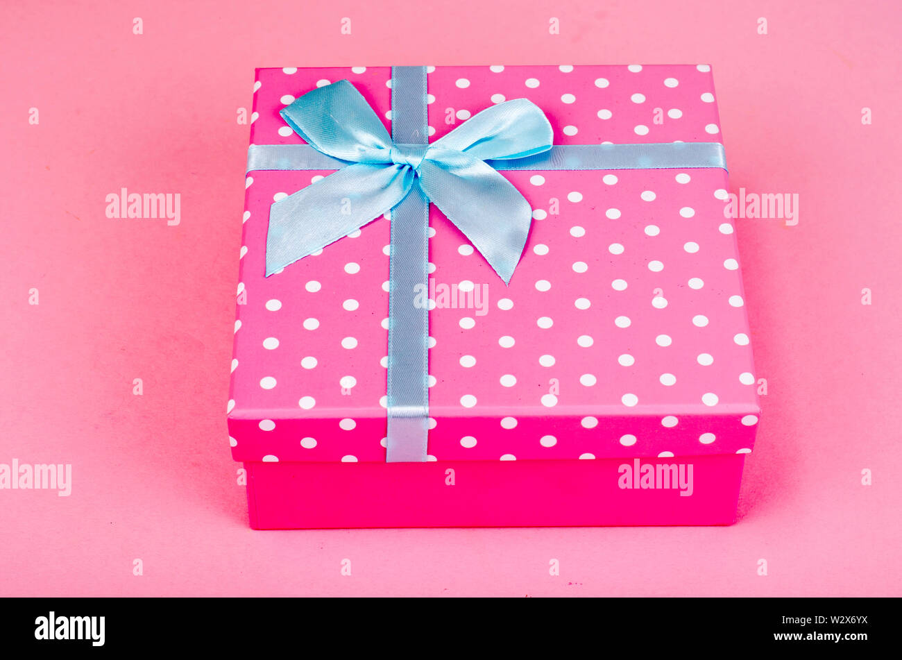 Square box of pink polka dots on bright background Stock Photo - Alamy