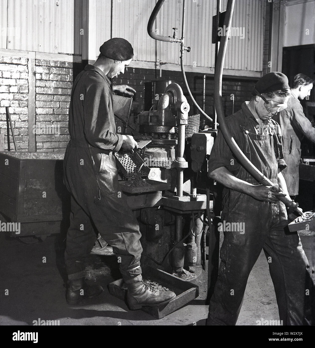 1950s, historical, male workers in overalls and berets using industrial ...