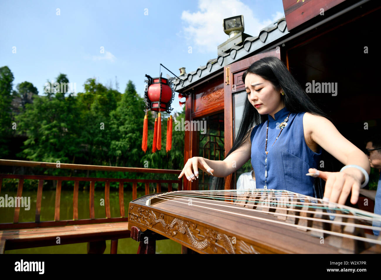 Chongqing, China's Chongqing. 10th July, 2019. A woman plays the ...
