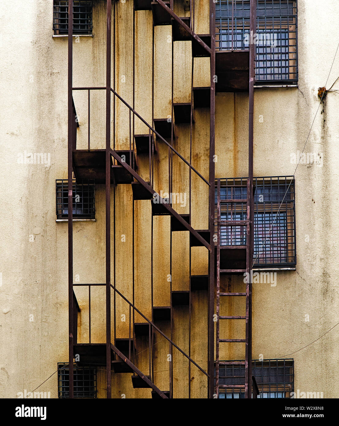 Urban building back alley fire escape rusty stairs on aged wall Stock ...