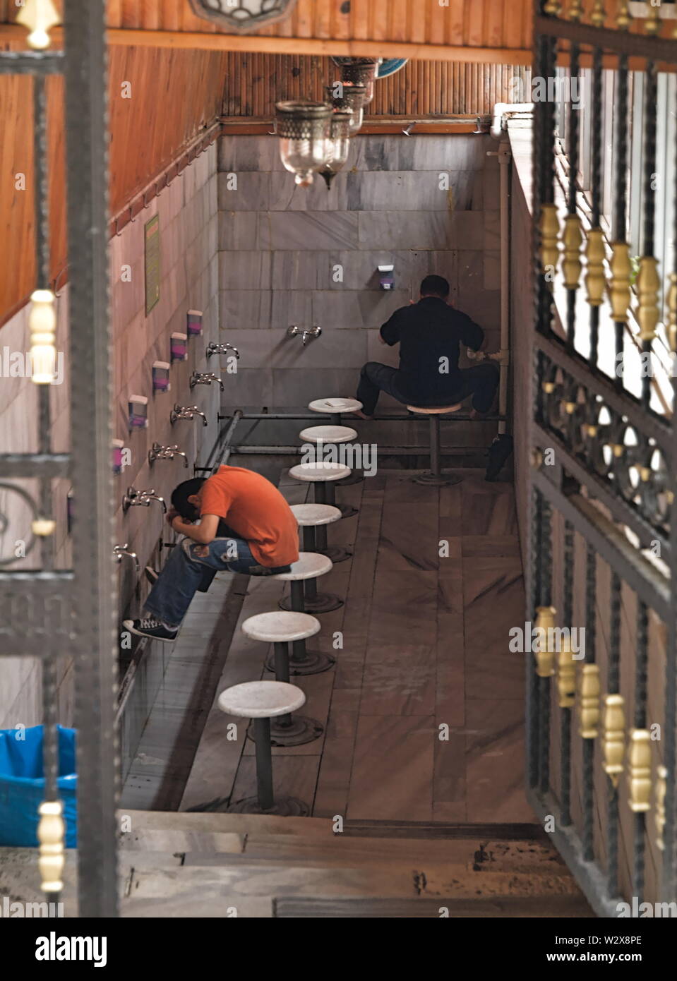 Two muslim men perform ablution (wudhu) before prayer, Istanbul, Turkey ...