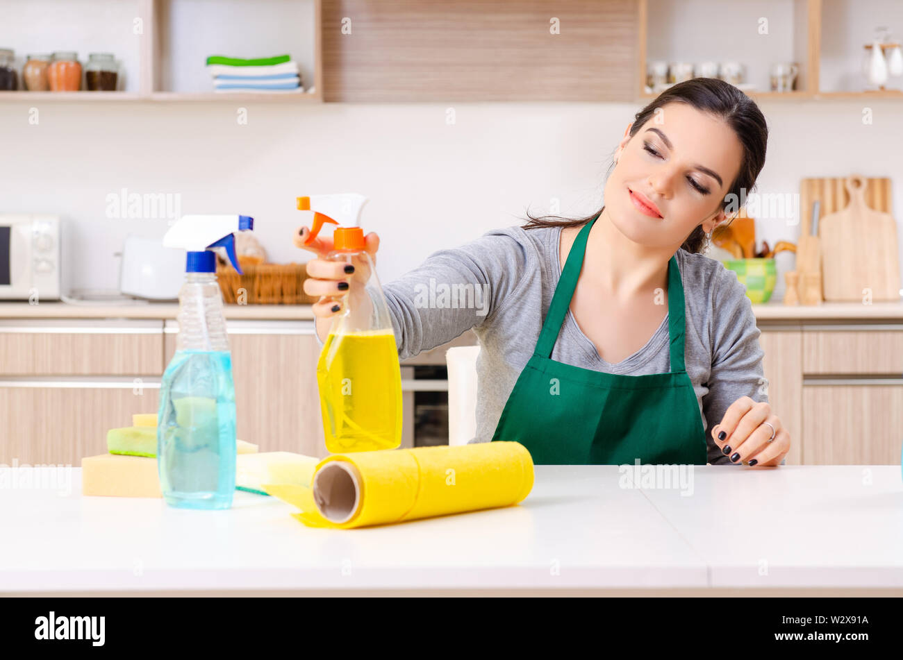 The young female contractor doing housework Stock Photo - Alamy