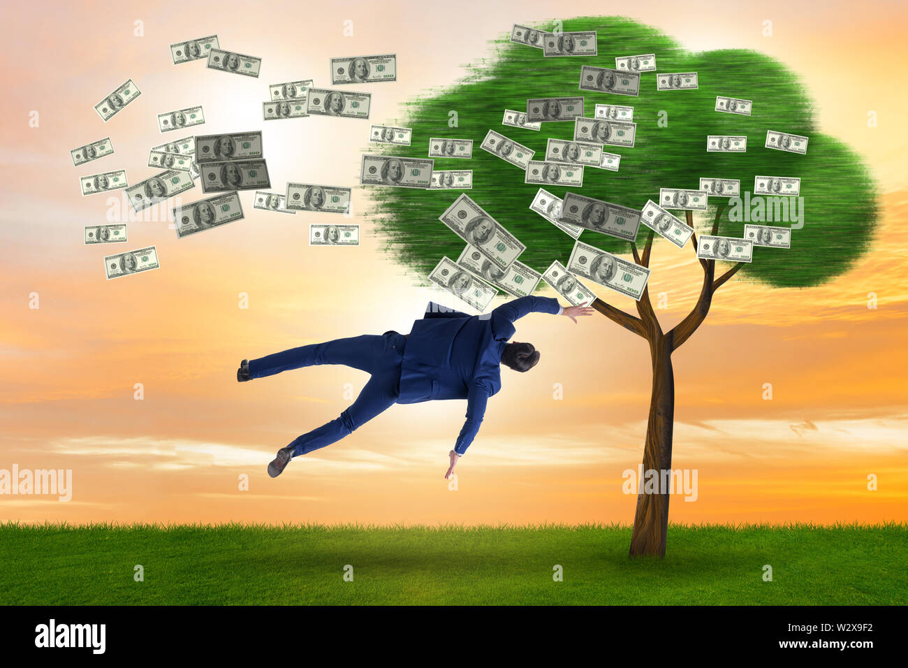The businessman blown away from the money tree Stock Photo - Alamy