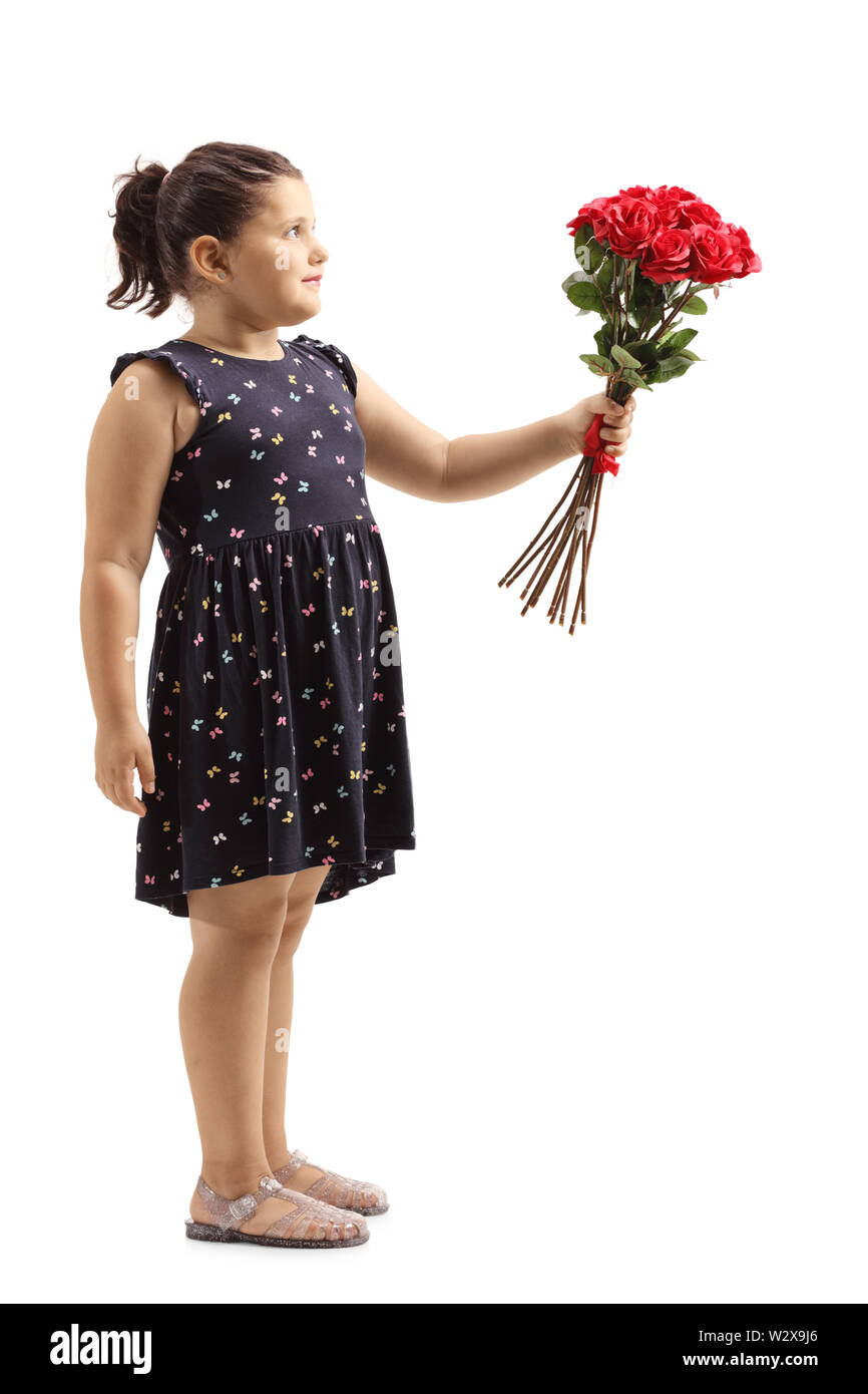 Full length shot of a little girl giving a bunch of red roses isolated ...