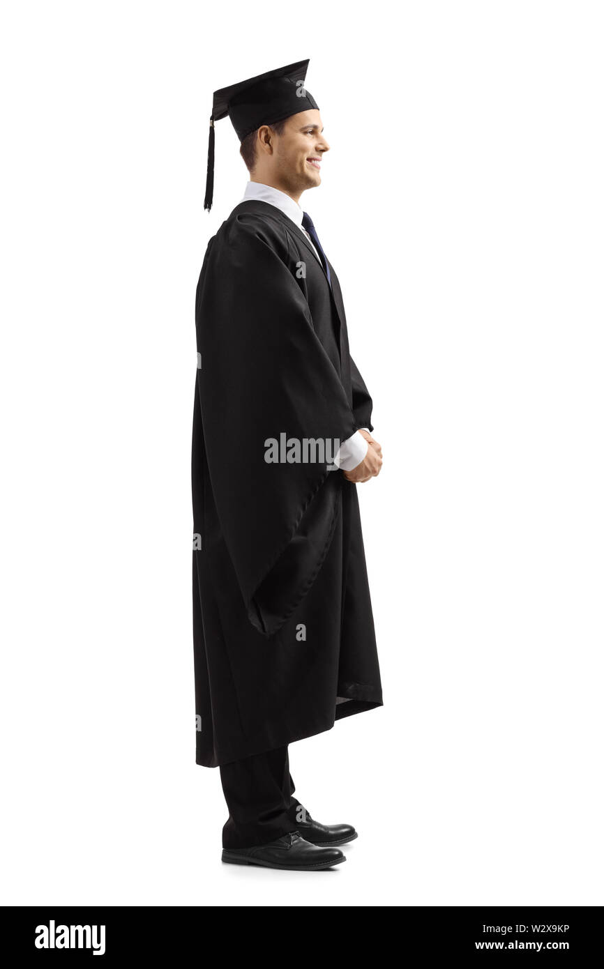 Full length profile shot of a happy young man in graduation gown ...