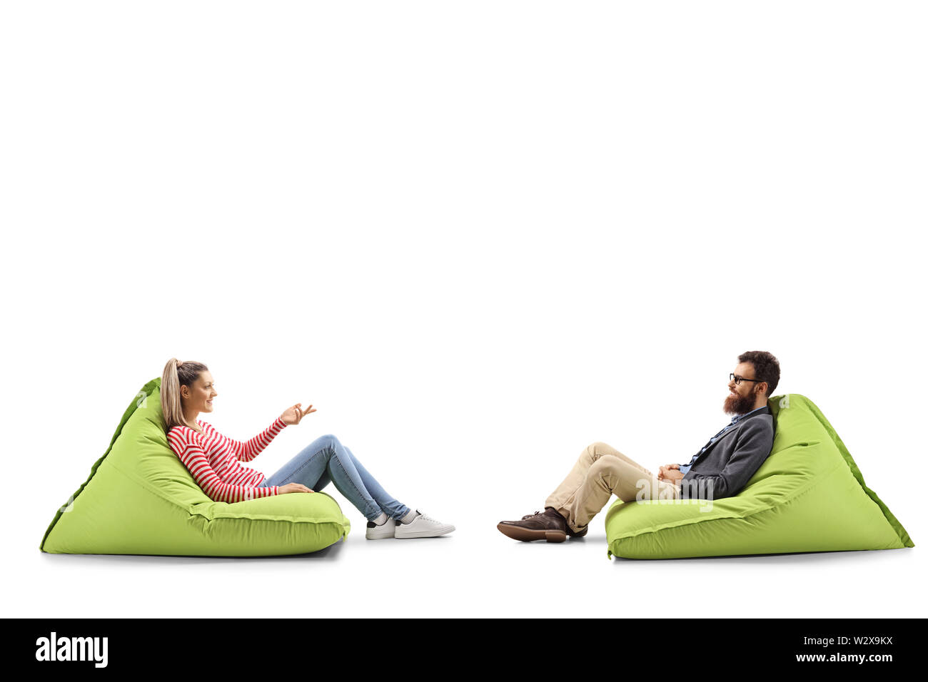 Full length profile shot of a young woman and a man sitting on bean ...