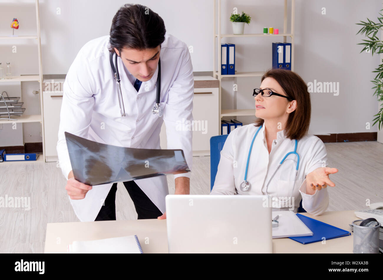 The two doctors working in the clinic Stock Photo - Alamy