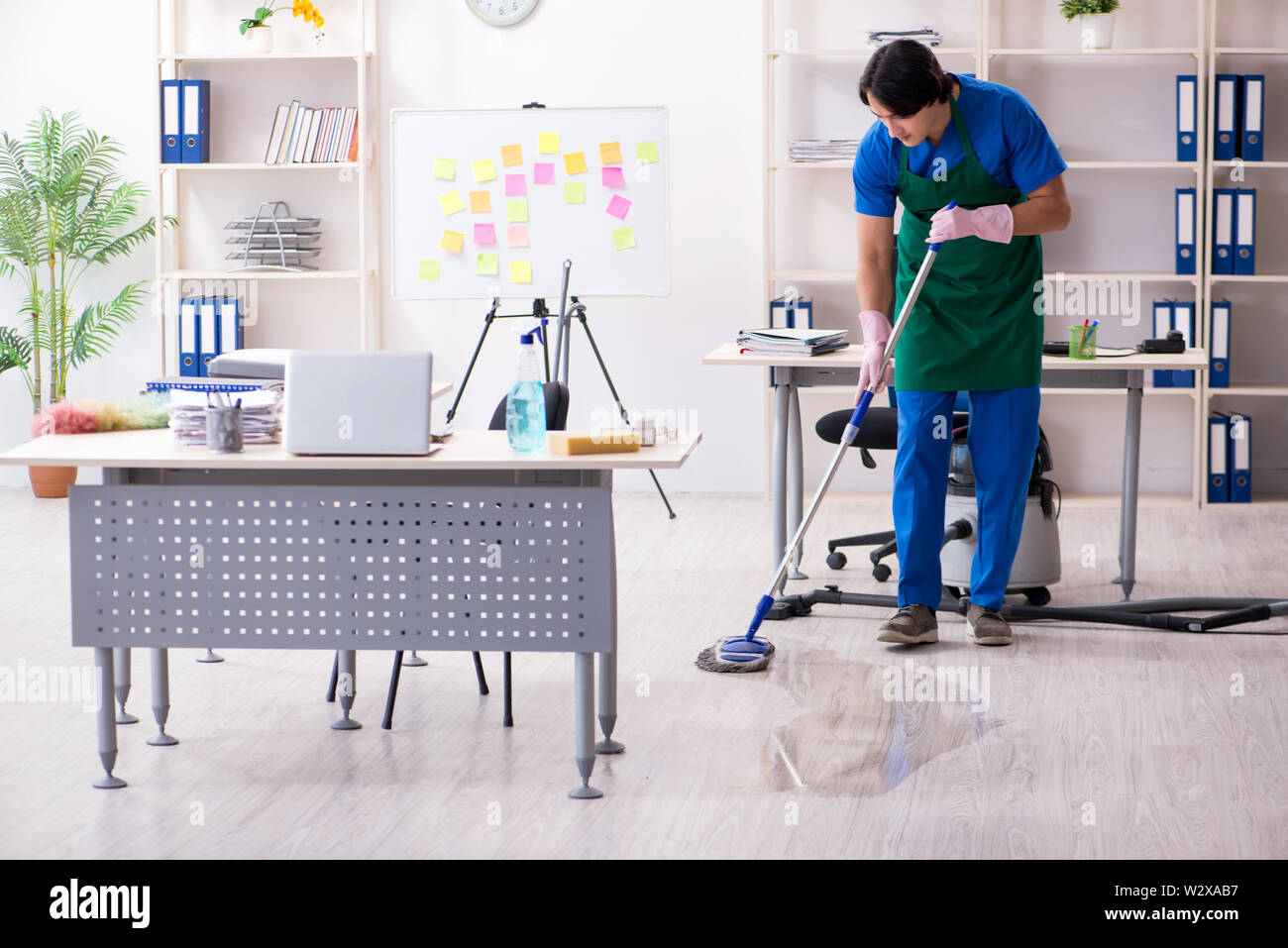 The male handsome professional cleaner working in the office Stock ...