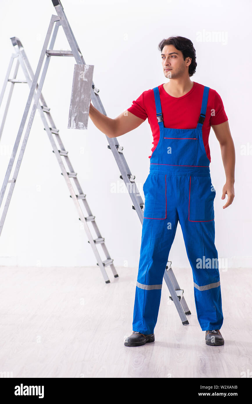 The young handsome contractor working indoors Stock Photo - Alamy