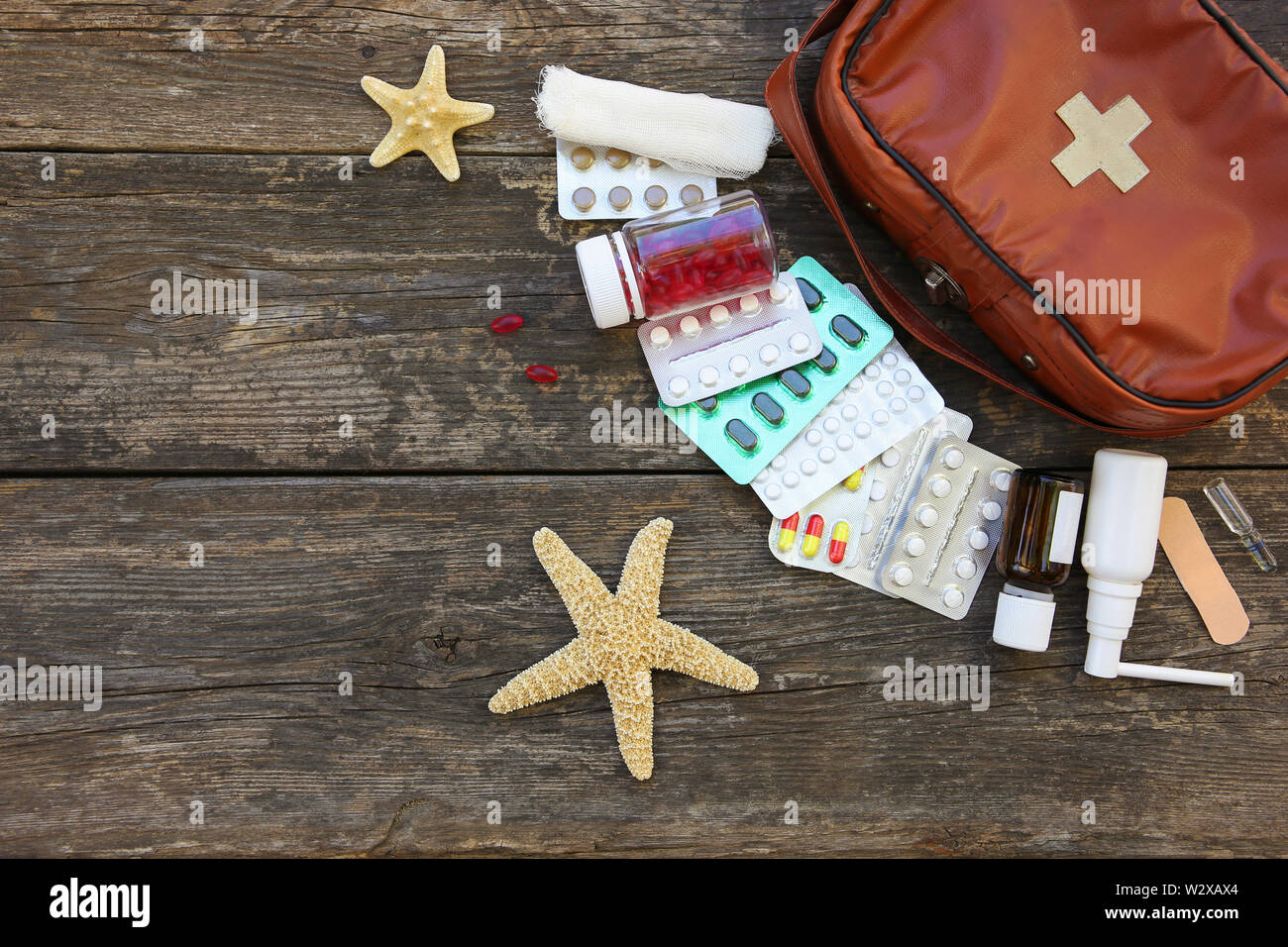 First aid kit on old wooden background. Concept of medication required ...