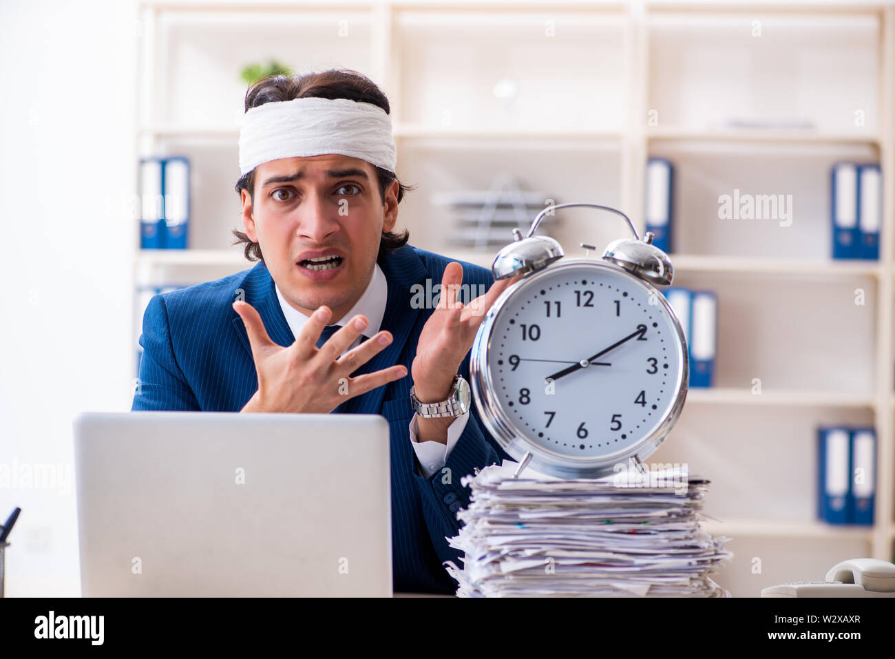 The head injured male employee working in the office Stock Photo - Alamy