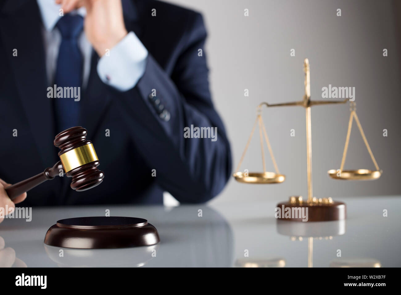 Judge in the courtroom. Male judge striking the gavel Stock Photo - Alamy