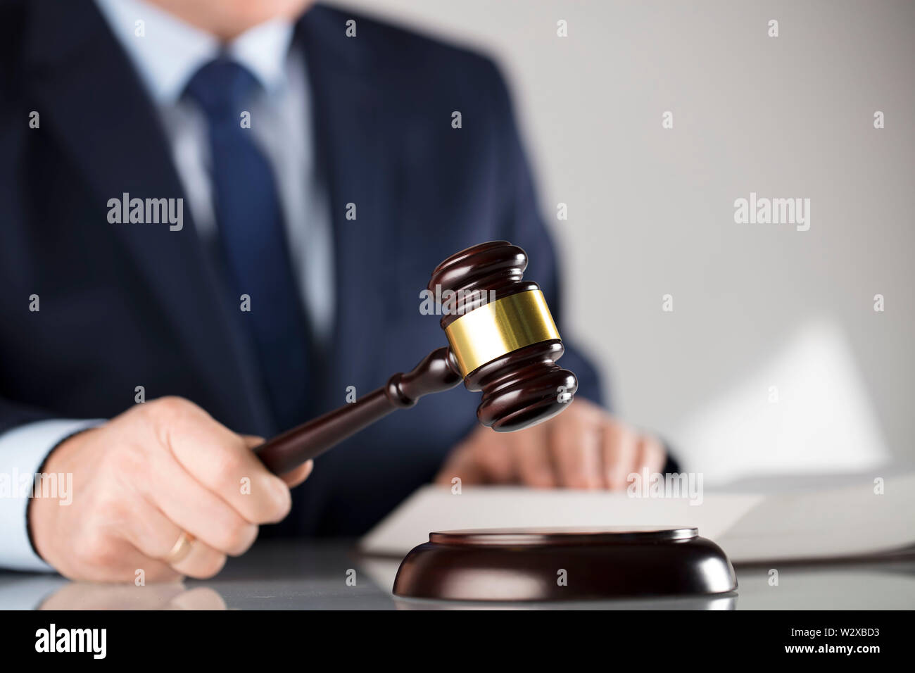 Judge in the courtroom. Male judge striking the gavel Stock Photo - Alamy