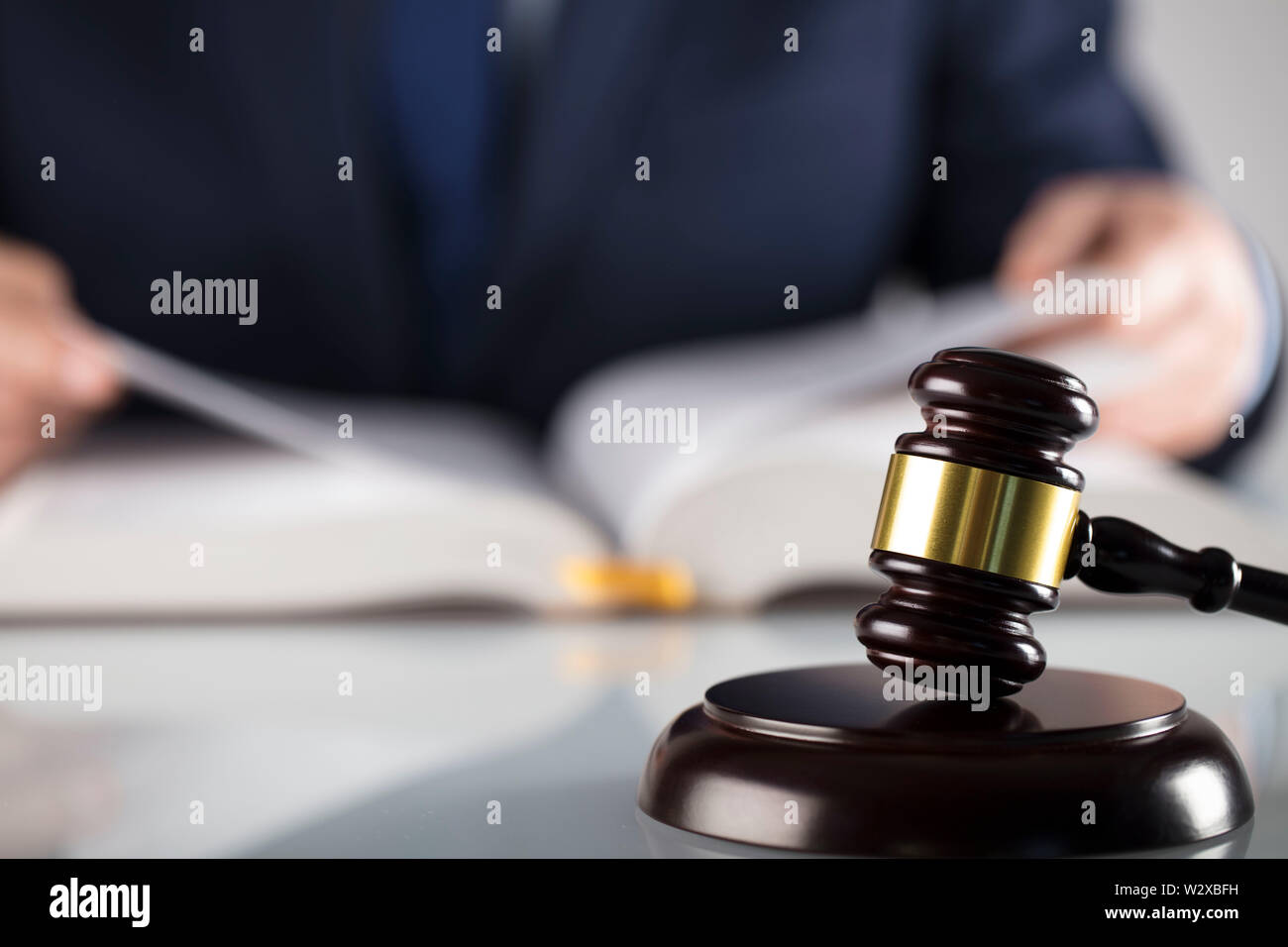 Judge in the courtroom. Male judge striking the gavel Stock Photo - Alamy