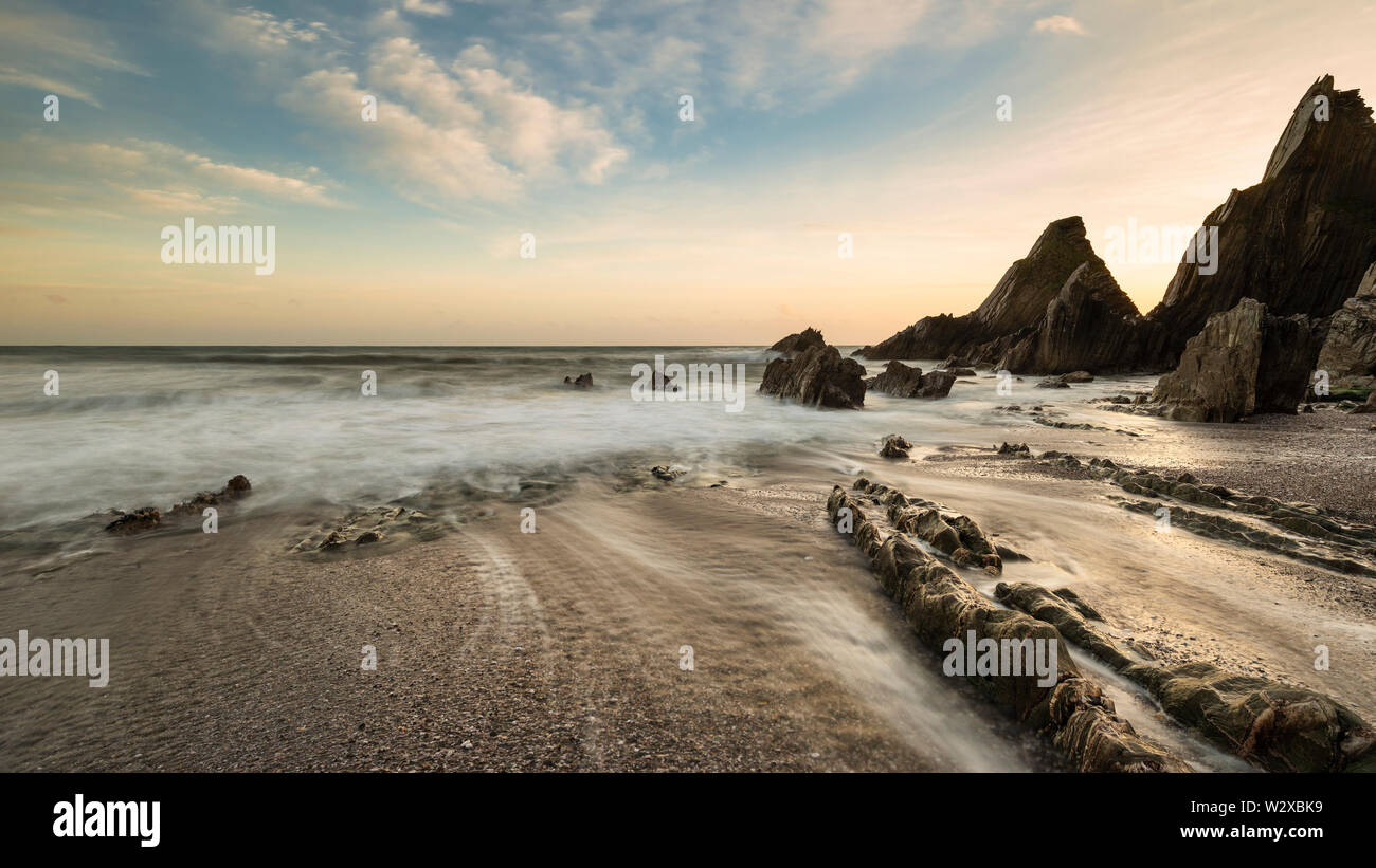Beautiful sunset landscape image of Westcombe Beach in Devon England ...
