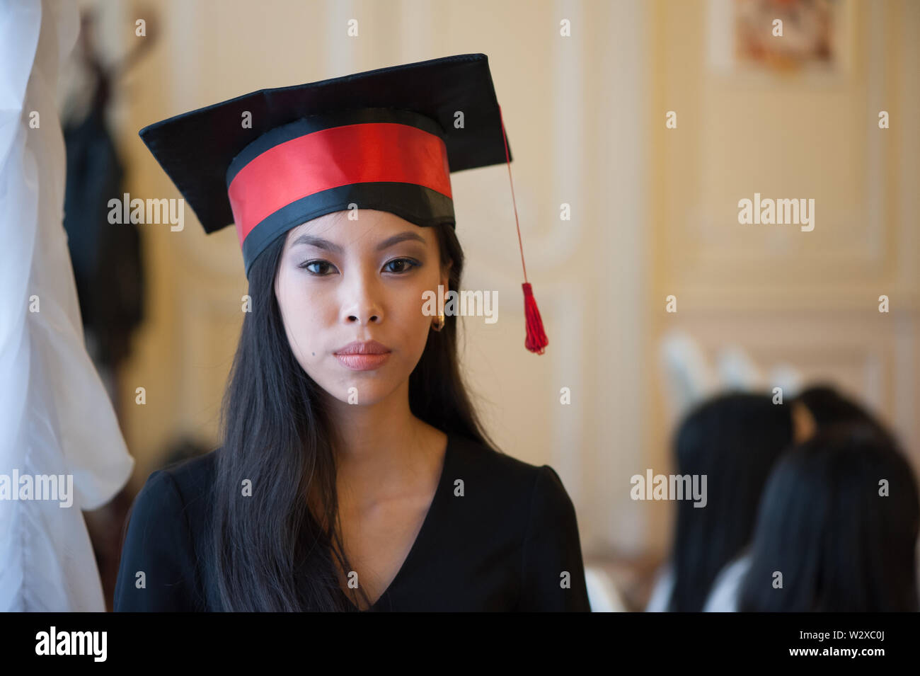 Portrait of young asian woman in graduation cap indoors Stock Photo - Alamy
