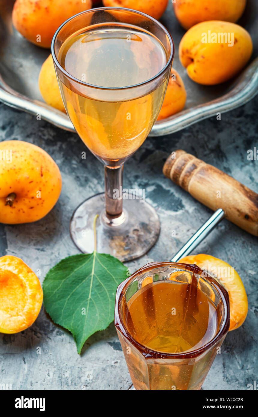 Ripe apricot wine.Alcoholic drink.Fruit wine or liquor in glass Stock ...
