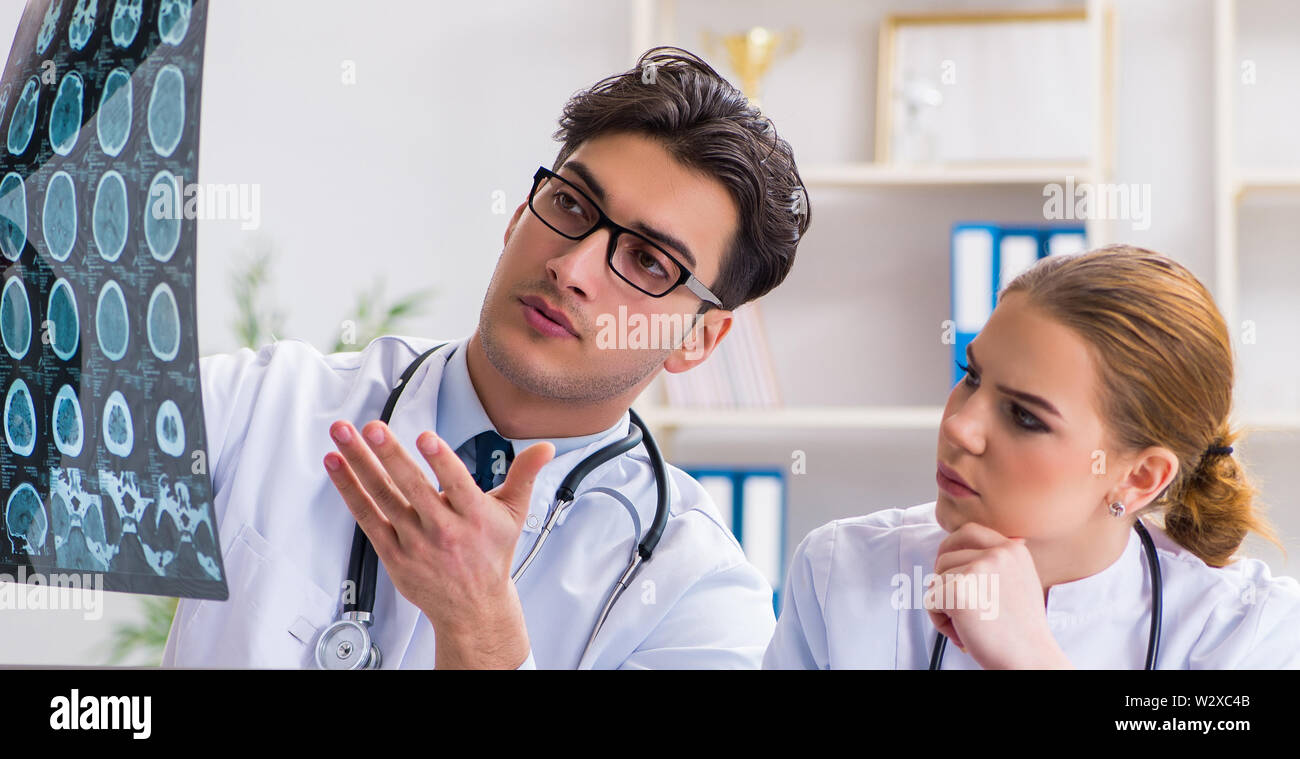 The two doctors examining x-ray images of patient for diagnosis Stock ...