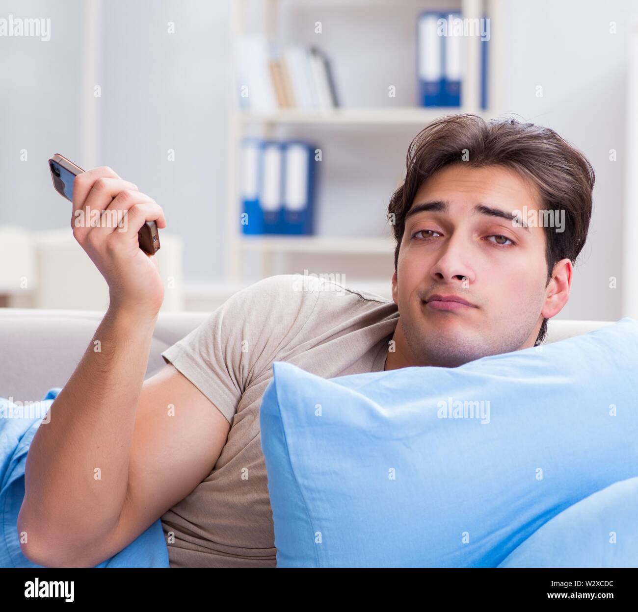 The man addicted to his mobile phone in bed Stock Photo - Alamy
