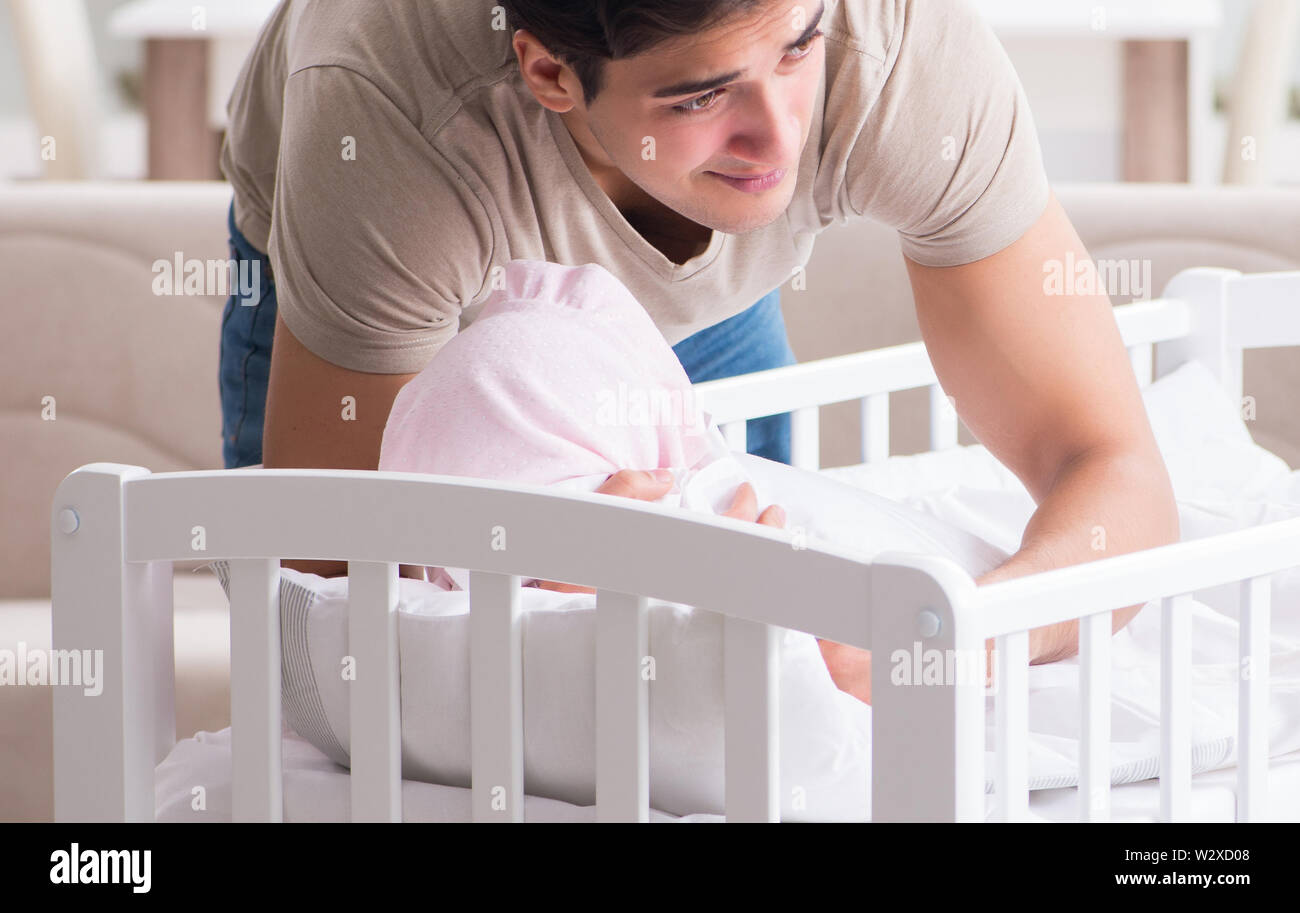 The young father dad frustrated at crying baby Stock Photo - Alamy