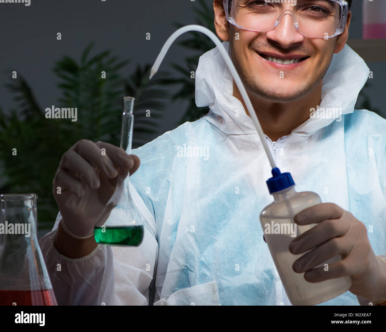 The young male lab chemist late at night in overtime time Stock Photo ...