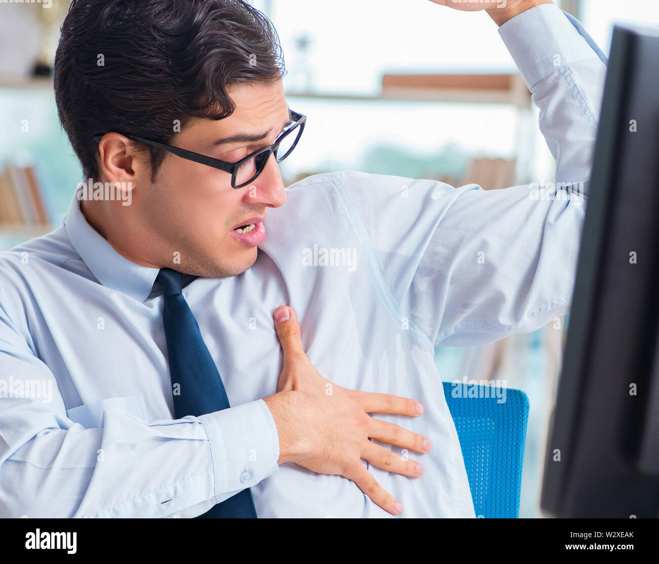 The businessman suffering from excessive armpit sweating Stock Photo ...