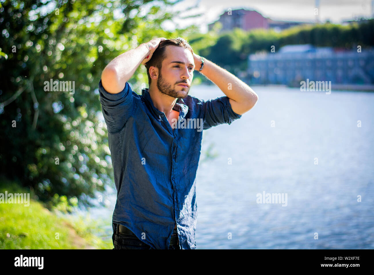 One handsome young man by river in city Stock Photo - Alamy