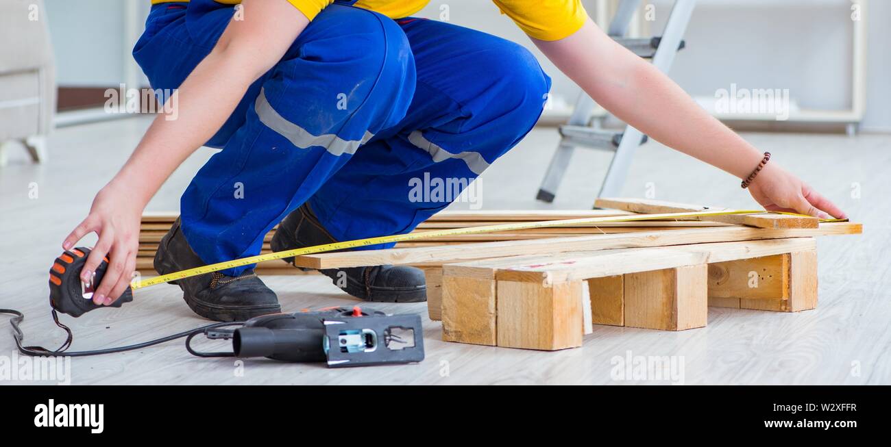 The young man assembling wood pallet Stock Photo - Alamy