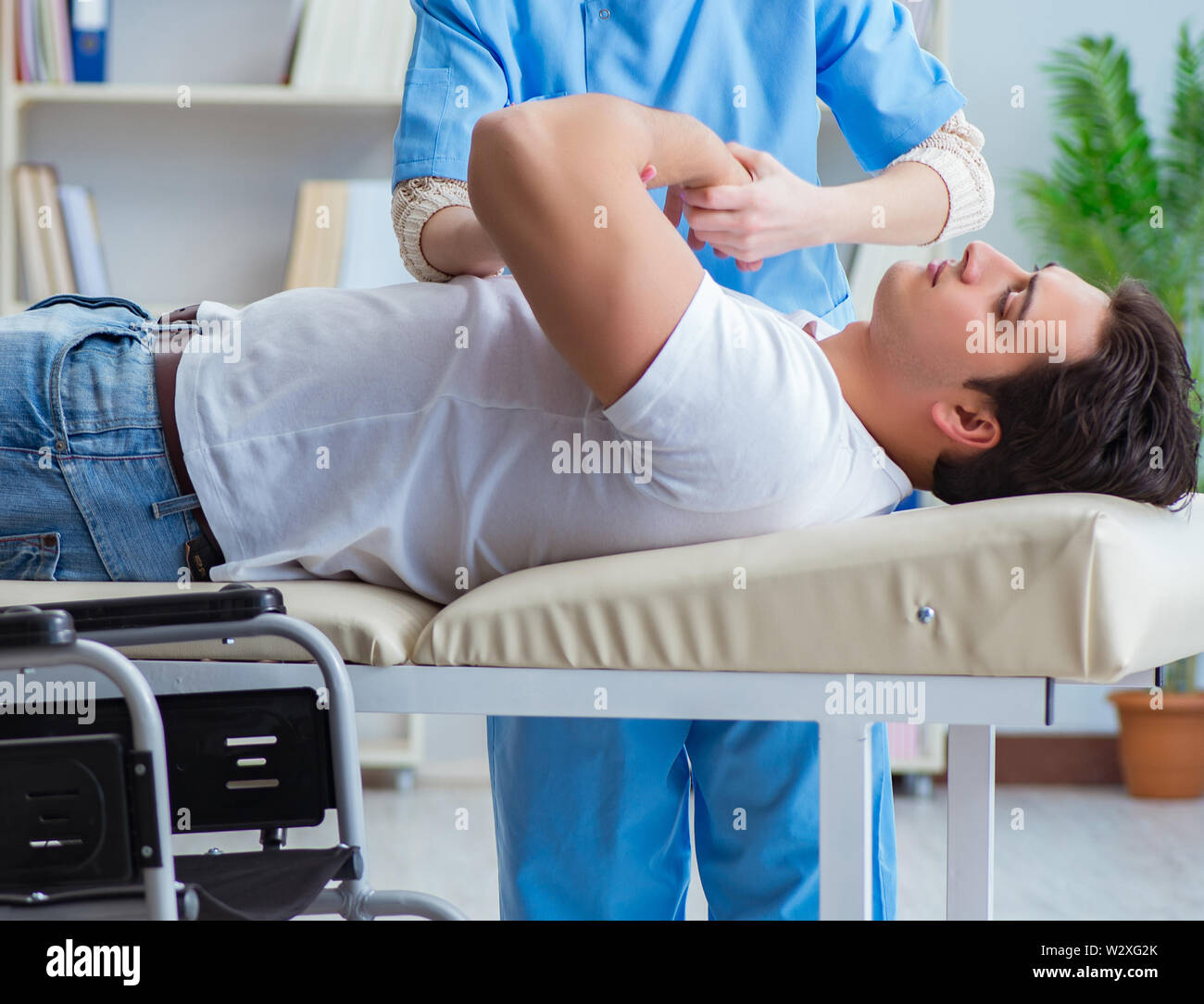 The patient undergoing rehabilitation recovery programme with doctor ...