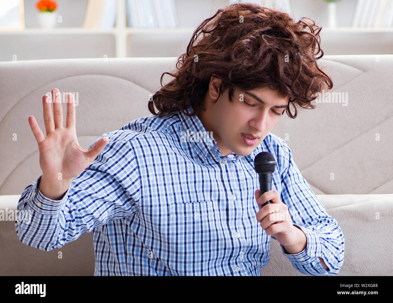 The funny man singing songs in karaoke at home Stock Photo - Alamy