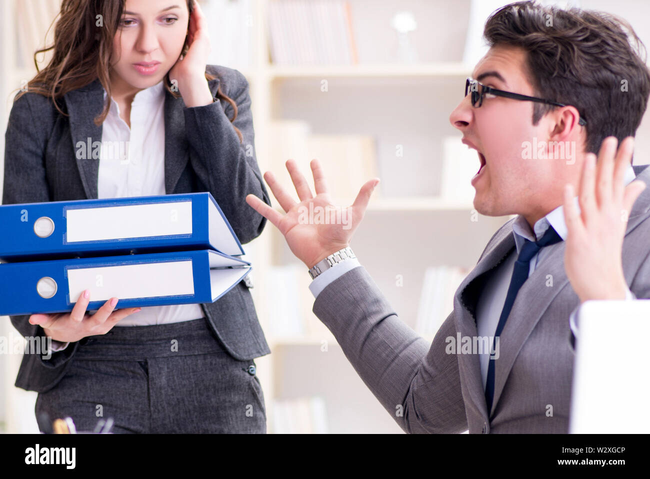 The angry boss unhappy with female employee performance Stock Photo - Alamy