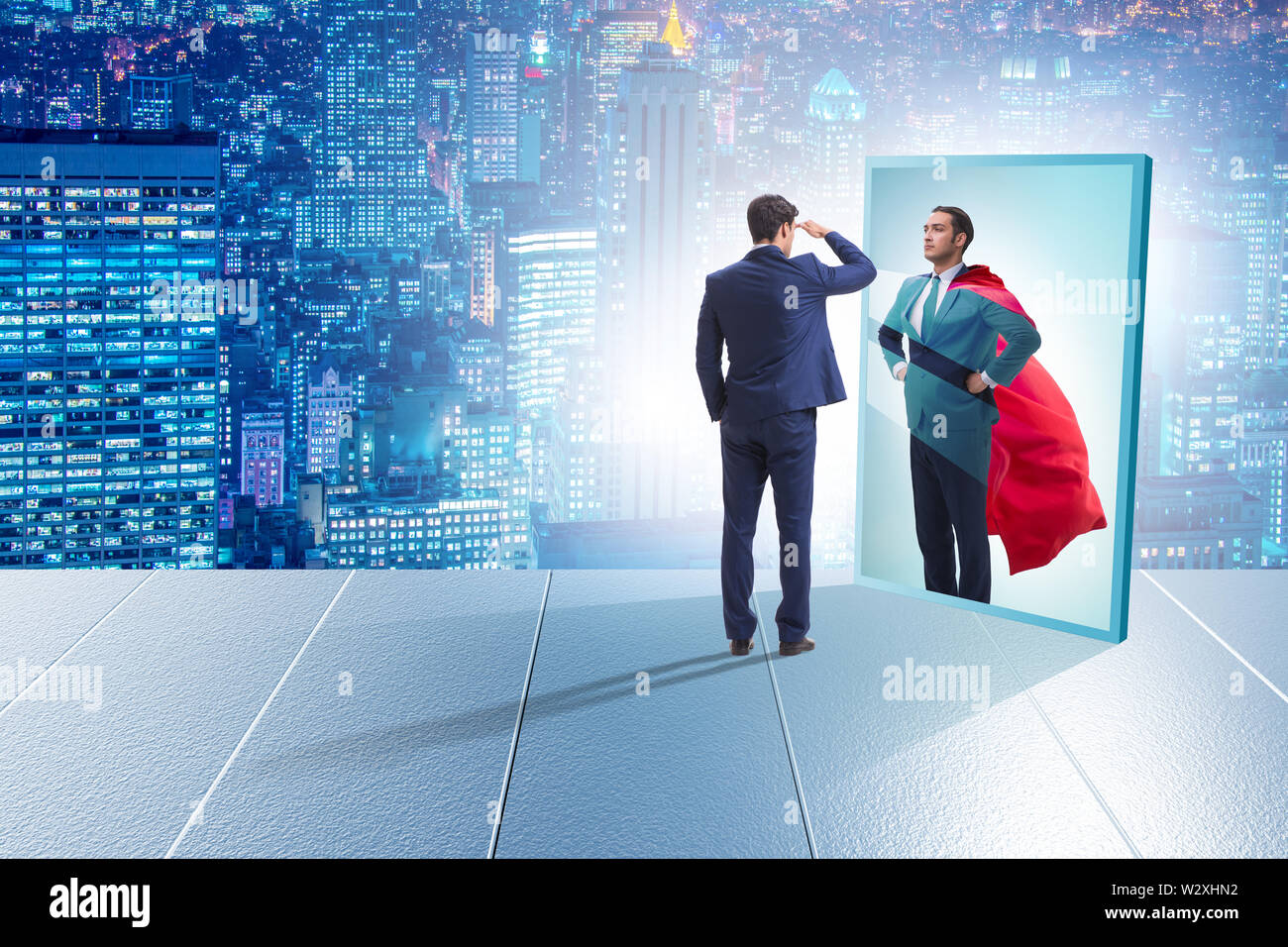 The businessman seeing himself in mirror as superhero Stock Photo - Alamy