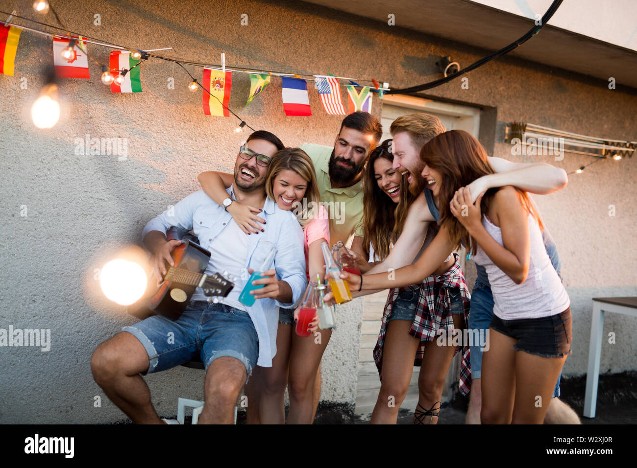 Group of happy friends having party on rooftop Stock Photo - Alamy