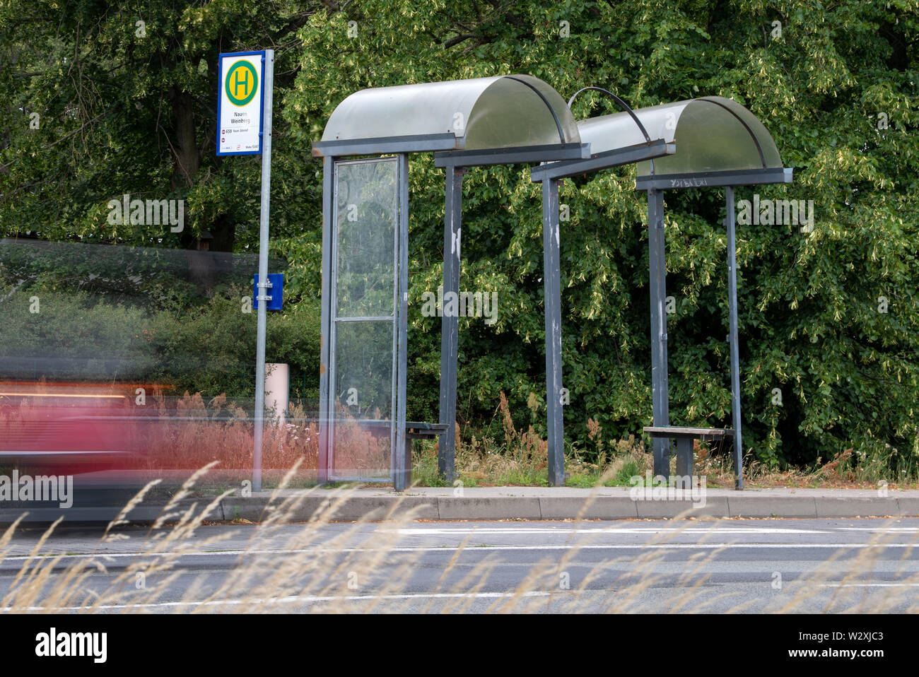 Nauen, Germany. 10th July, 2019. A car drives at a run down bus stop in ...