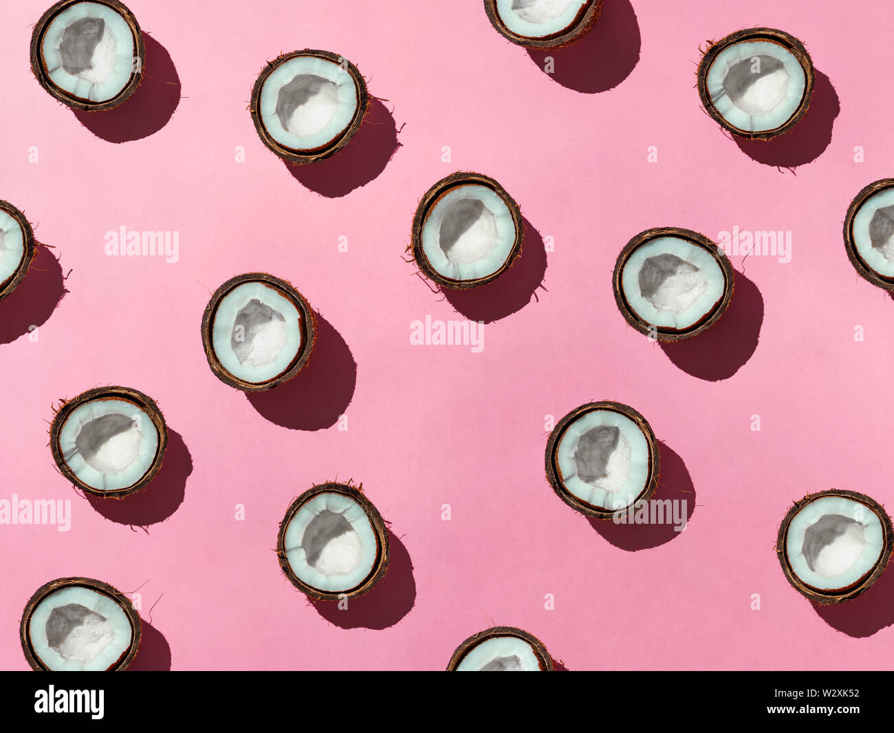 Creative layout of coconuts half on pink background. Tropical pattern ...