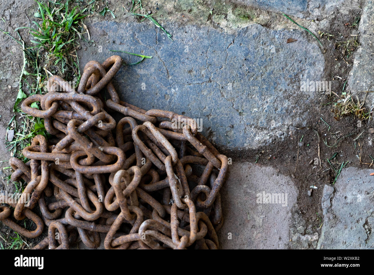 Rusty chain on the brickwork. The symbol of slave labor Stock Photo - Alamy