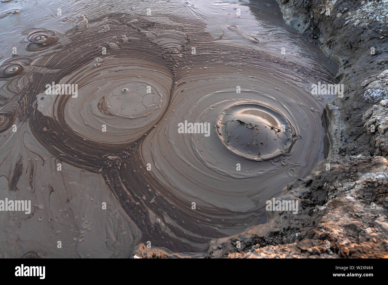 Mud volcano crater background texture Stock Photo - Alamy