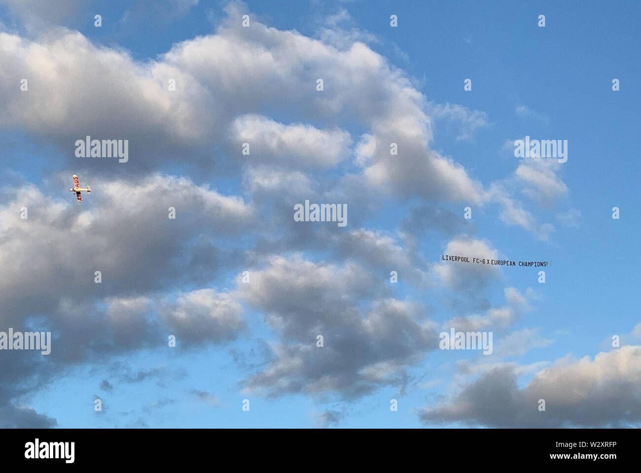 A plane with a banner reading 'Liverpool FC - 6 X European Champions ...