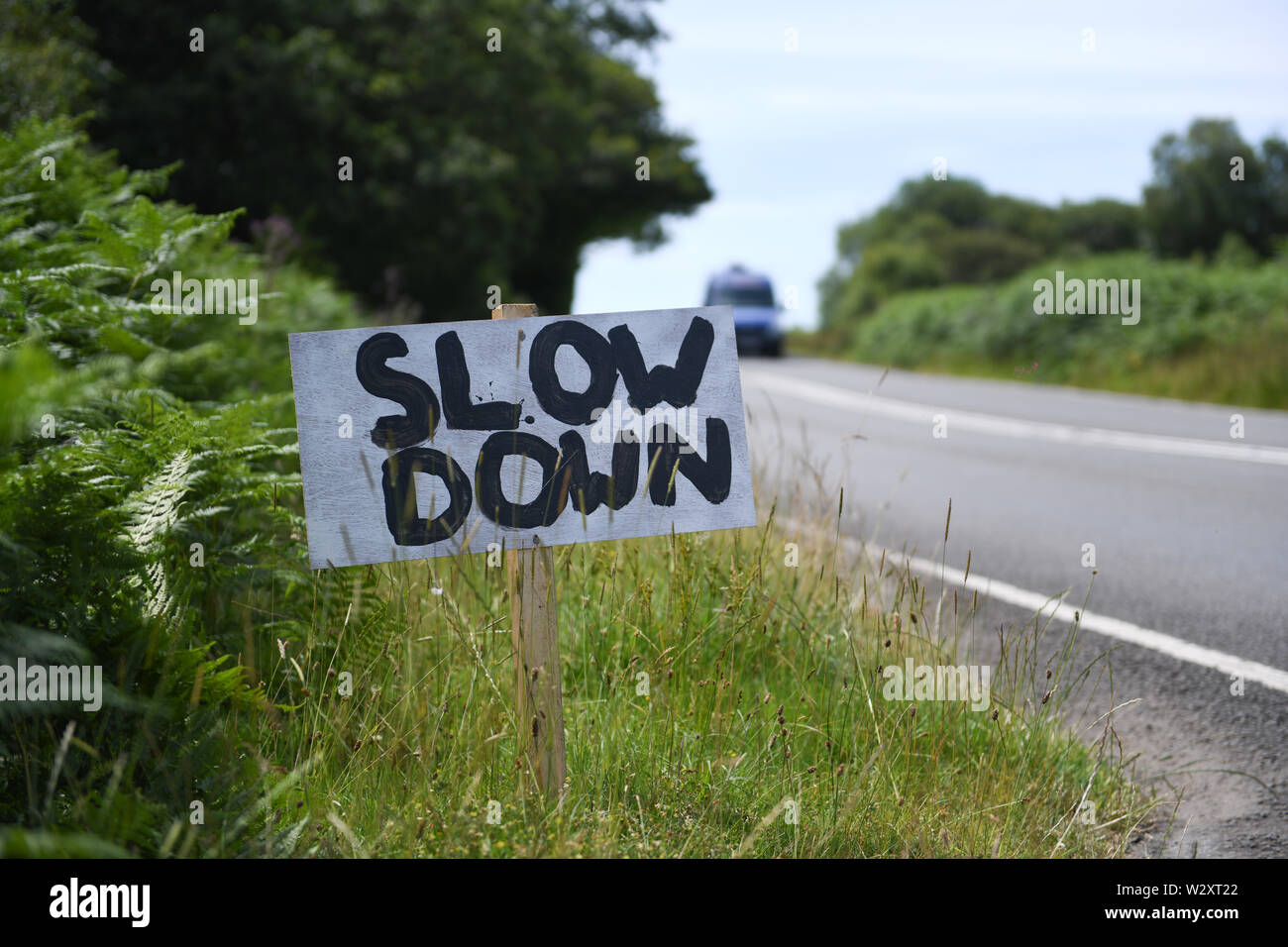 Slow down road sign hi-res stock photography and images - Alamy