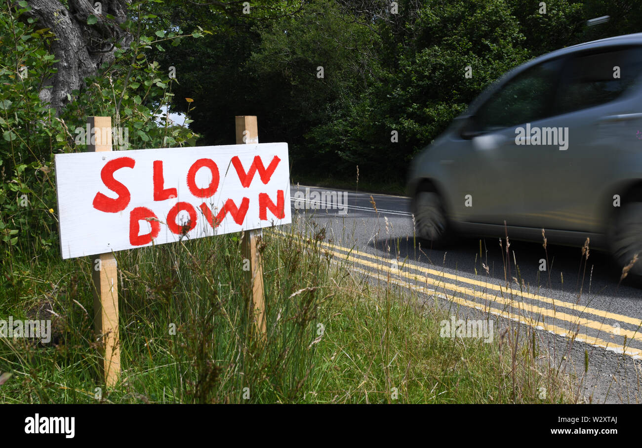 Slow down road sign hi-res stock photography and images - Alamy